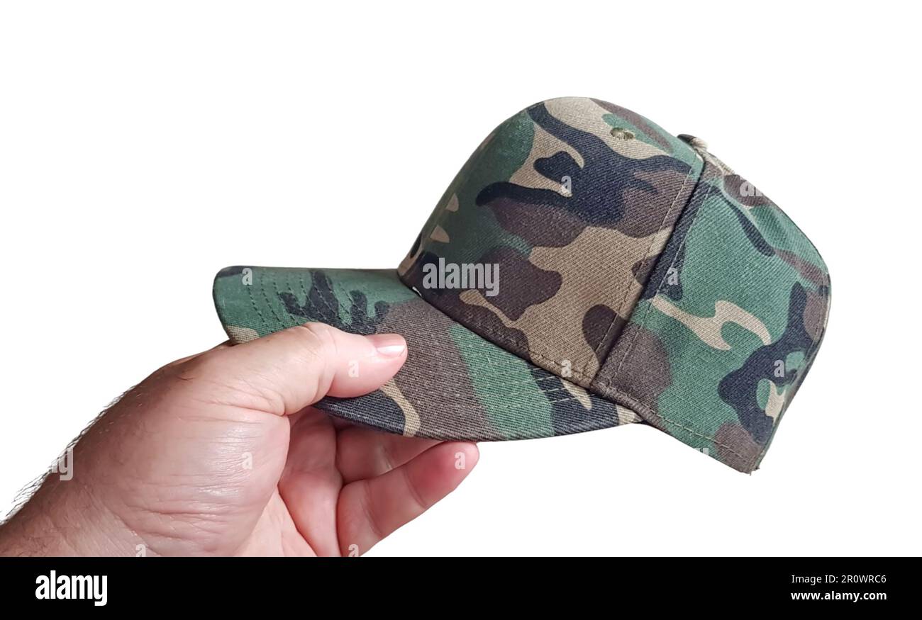 Hand holding camouflage cap Stock Photo - Alamy