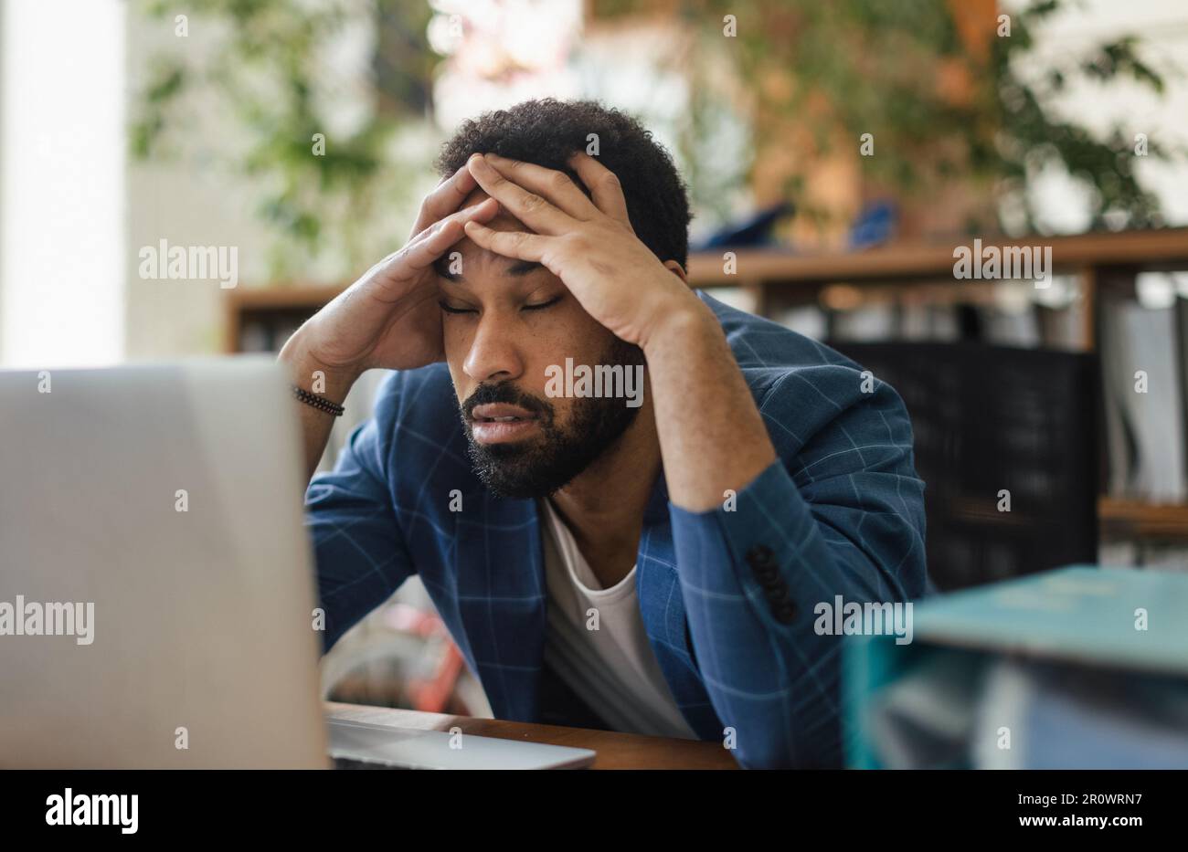Young frustrated man sitting in front of computer in his office Stock ...