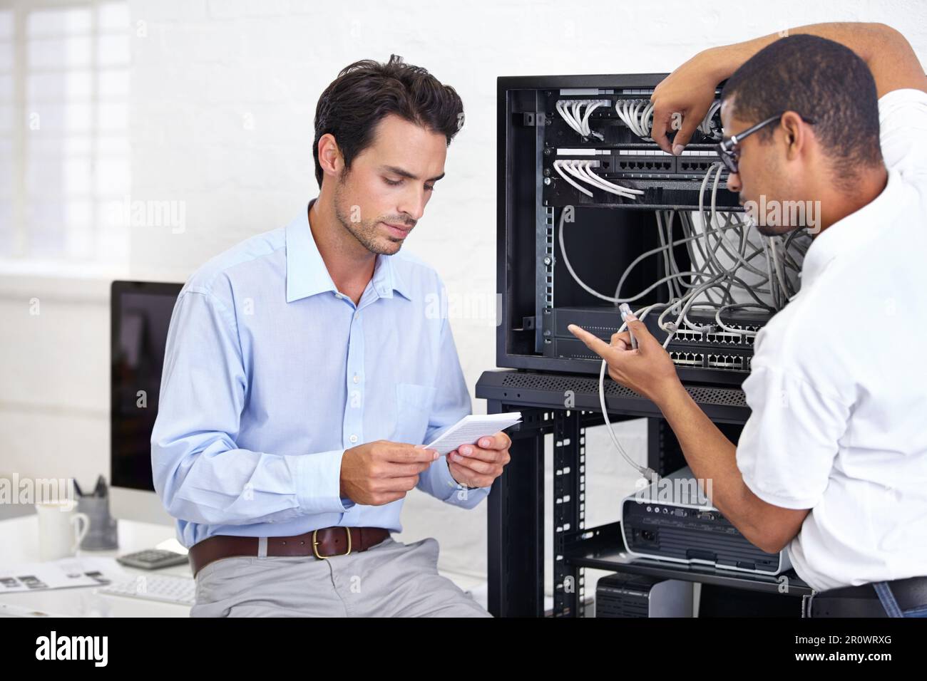 Server room, it support and instructions with a technician talking to a ...