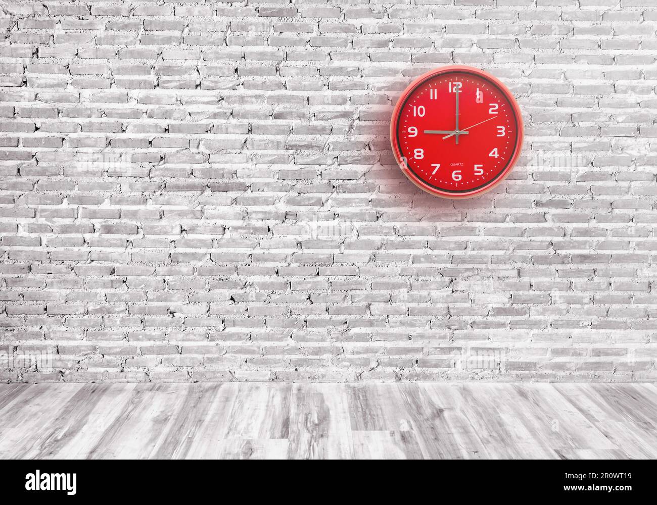 Red wall clock hanging on the wall inside the room Stock Photo - Alamy