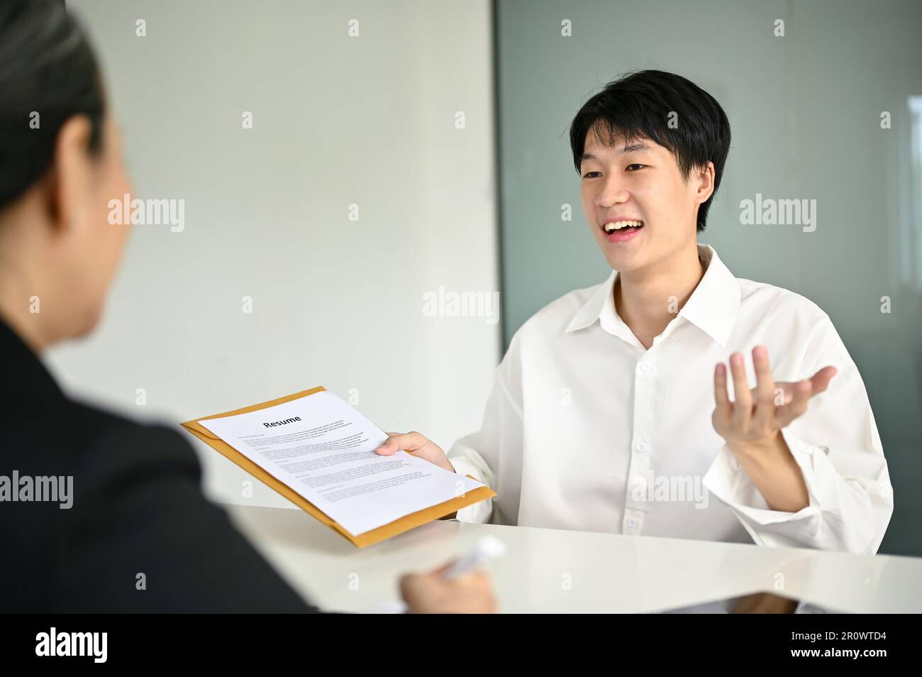Handsome and smart young Asian male candidate telling about his career ...