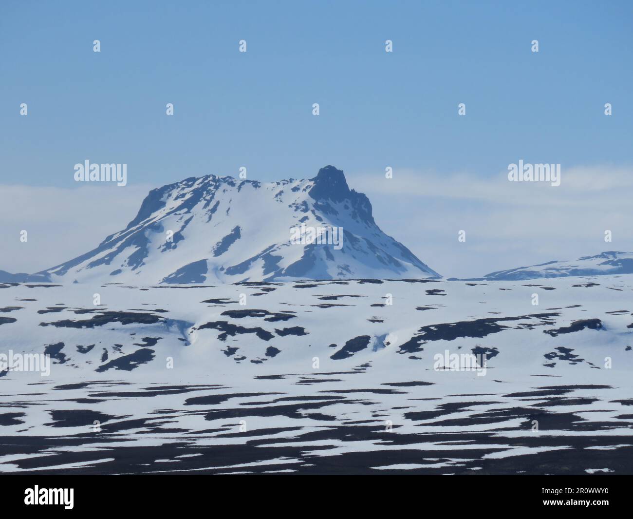 A picturesque winter scene of a snow-covered mountain set against a ...