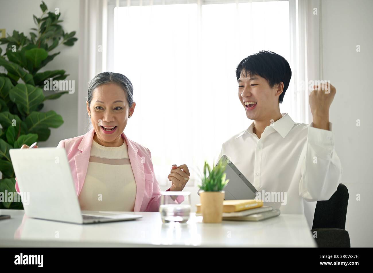 Young male employee celebrating hi-res stock photography and images - Alamy