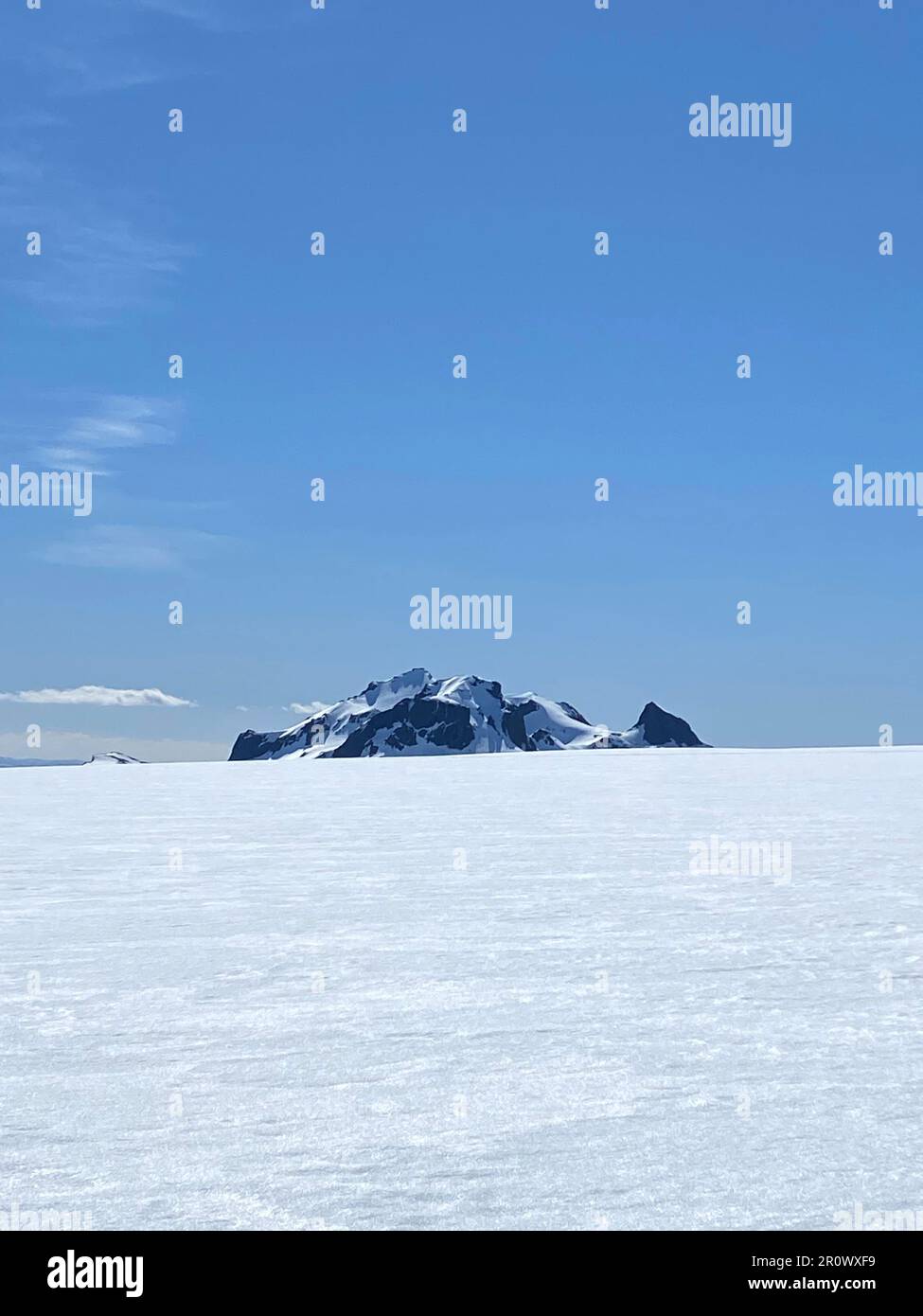 A majestic landscape featuring a large expanse of snow-covered terrain ...