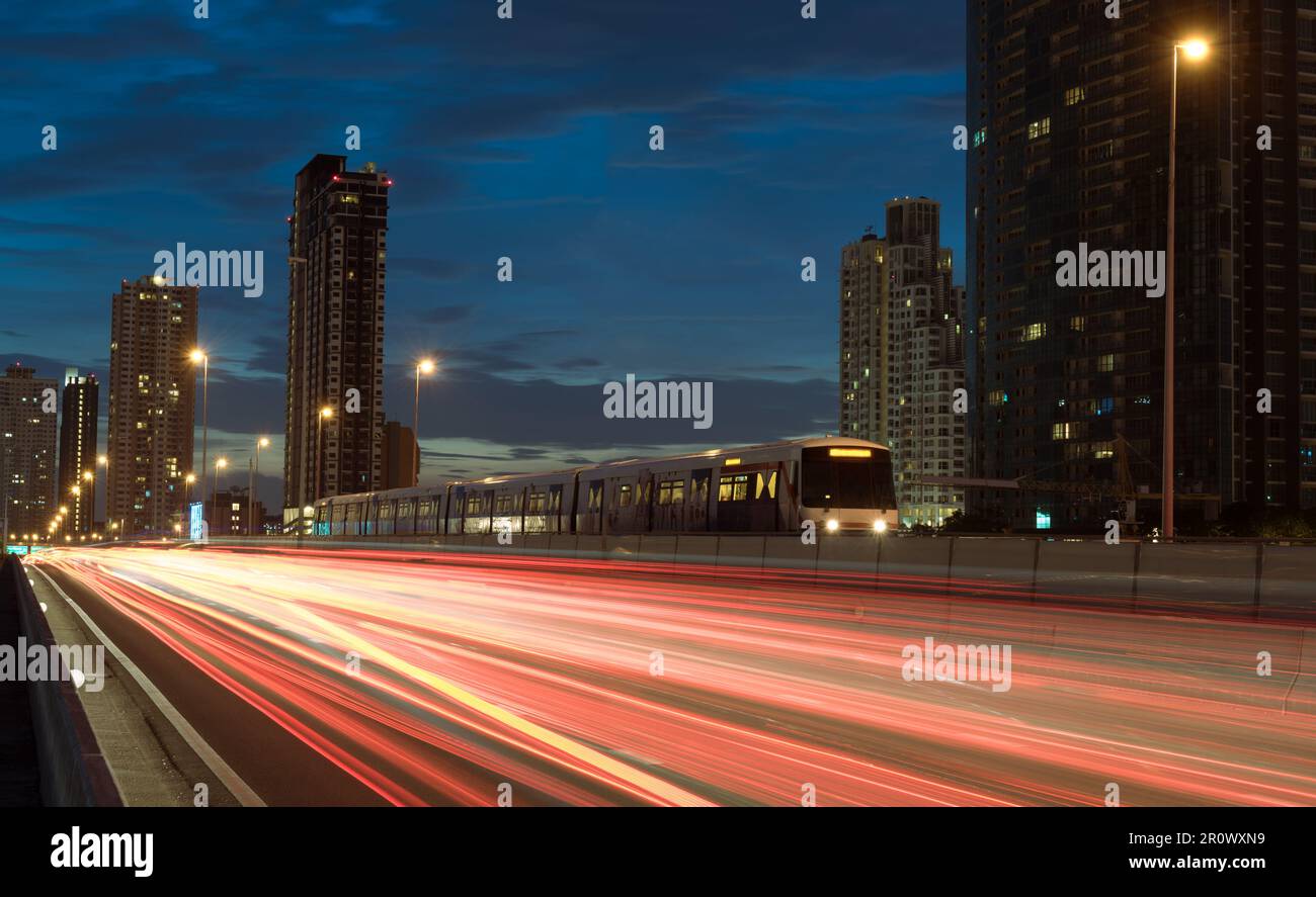 electric train with light trails on the highway at twilight light ...