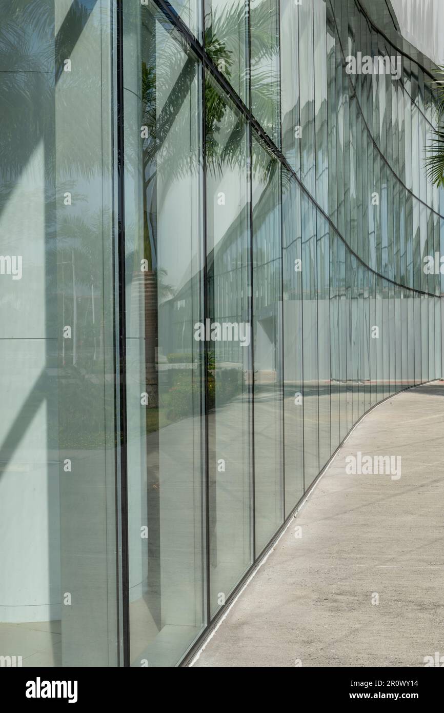 Outside a building with glass window, trees can be seen in the ...