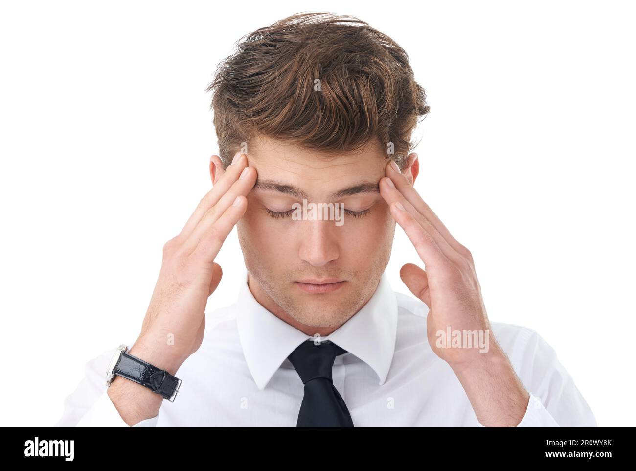 When the headache strikes...A young businessman rubbing his temple ...
