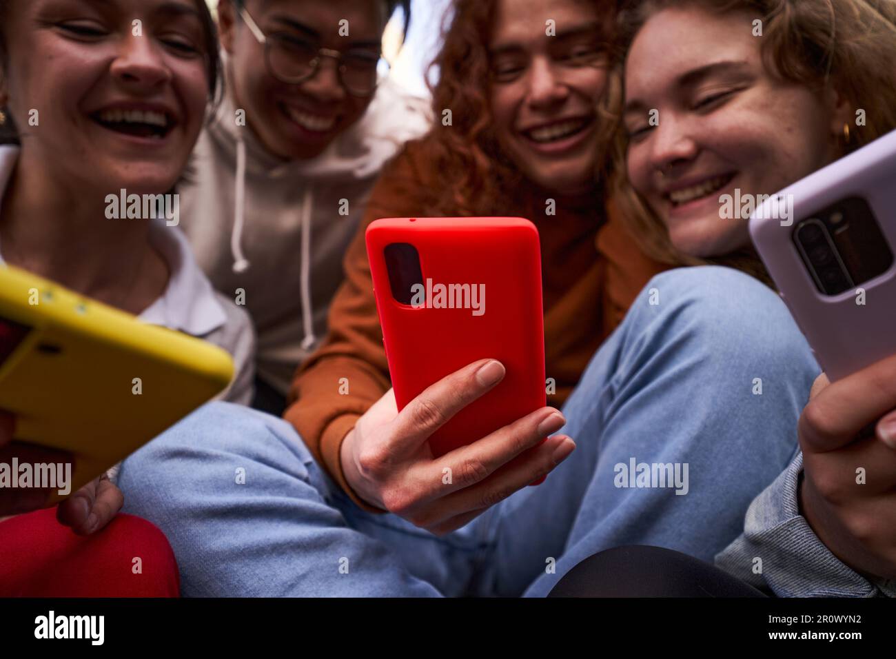 Group of friends gathering using smartphone all together watching ...