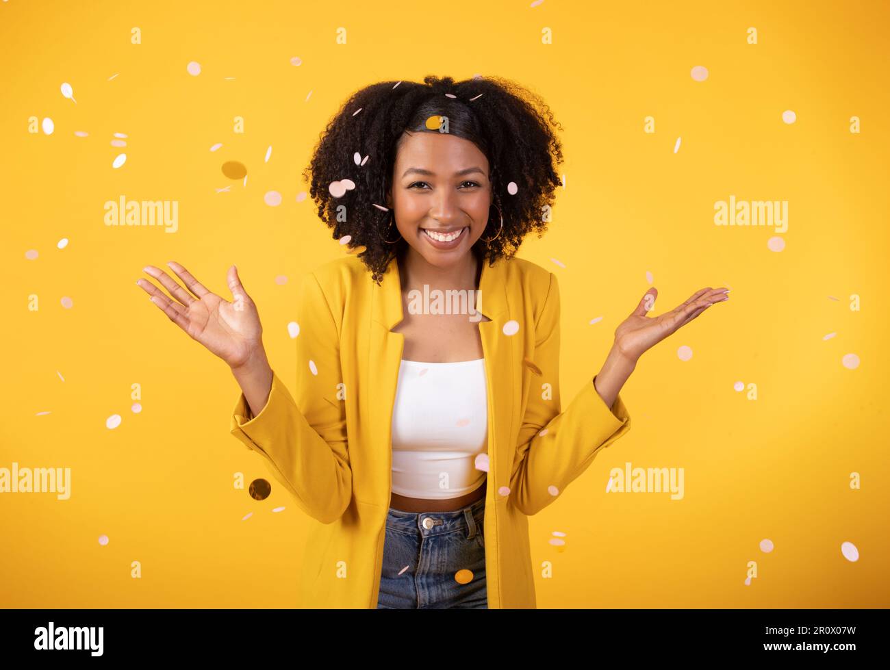 Holiday exuberance. Delighted young black lady ushering in festive ...