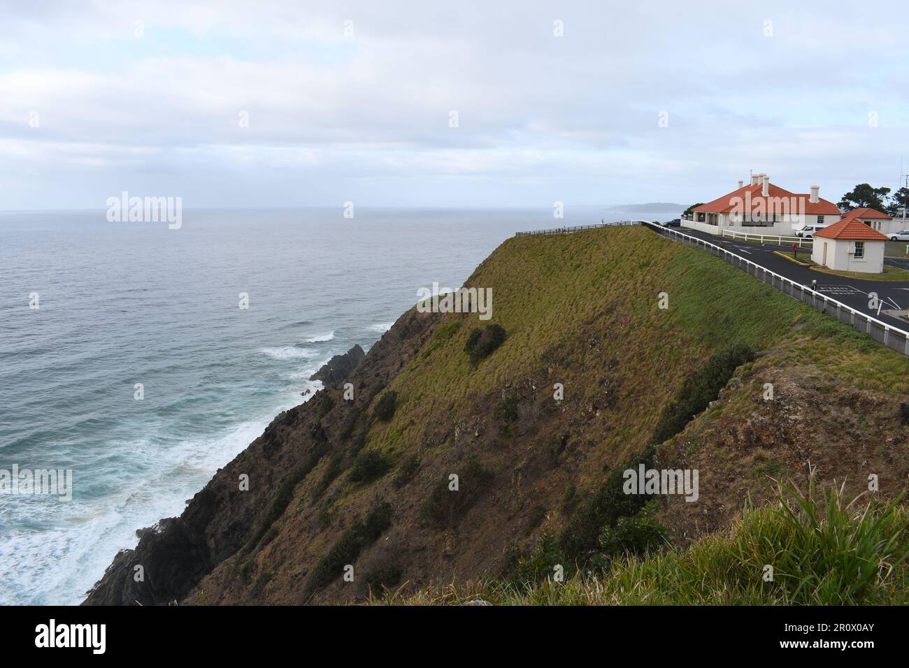 Aerial top view of ocean's beautiful waves crashing on the rocky cliff ...