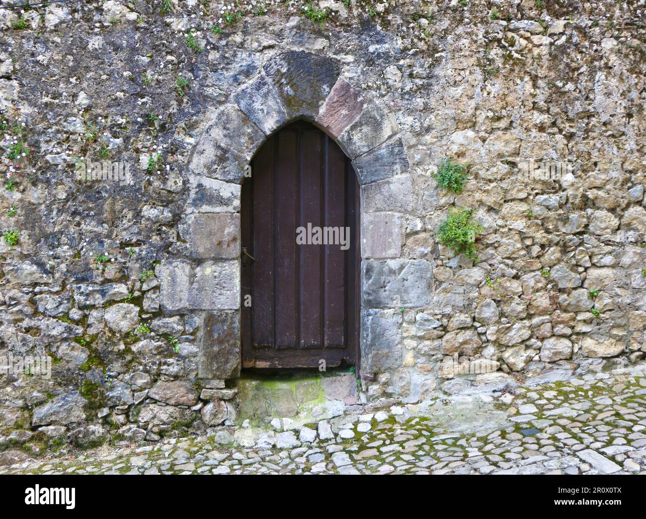 Wooden door in a stone wall Santillana del Mar Cantabria Spain Stock ...