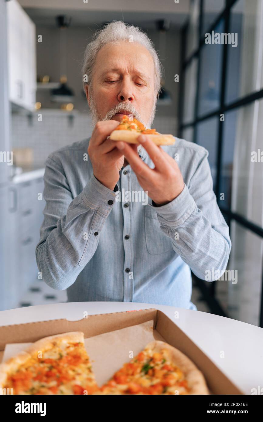 Vertical portrait of happy senior older man with grey hair enjoying to ...