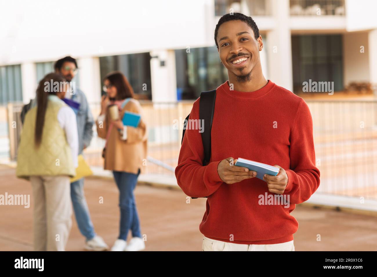 Positive millennial black man student in casual with books ready to ...