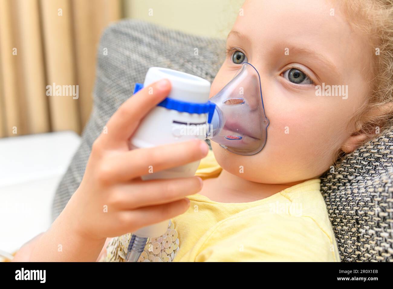 The child breathes through an inhaler Stock Photo - Alamy