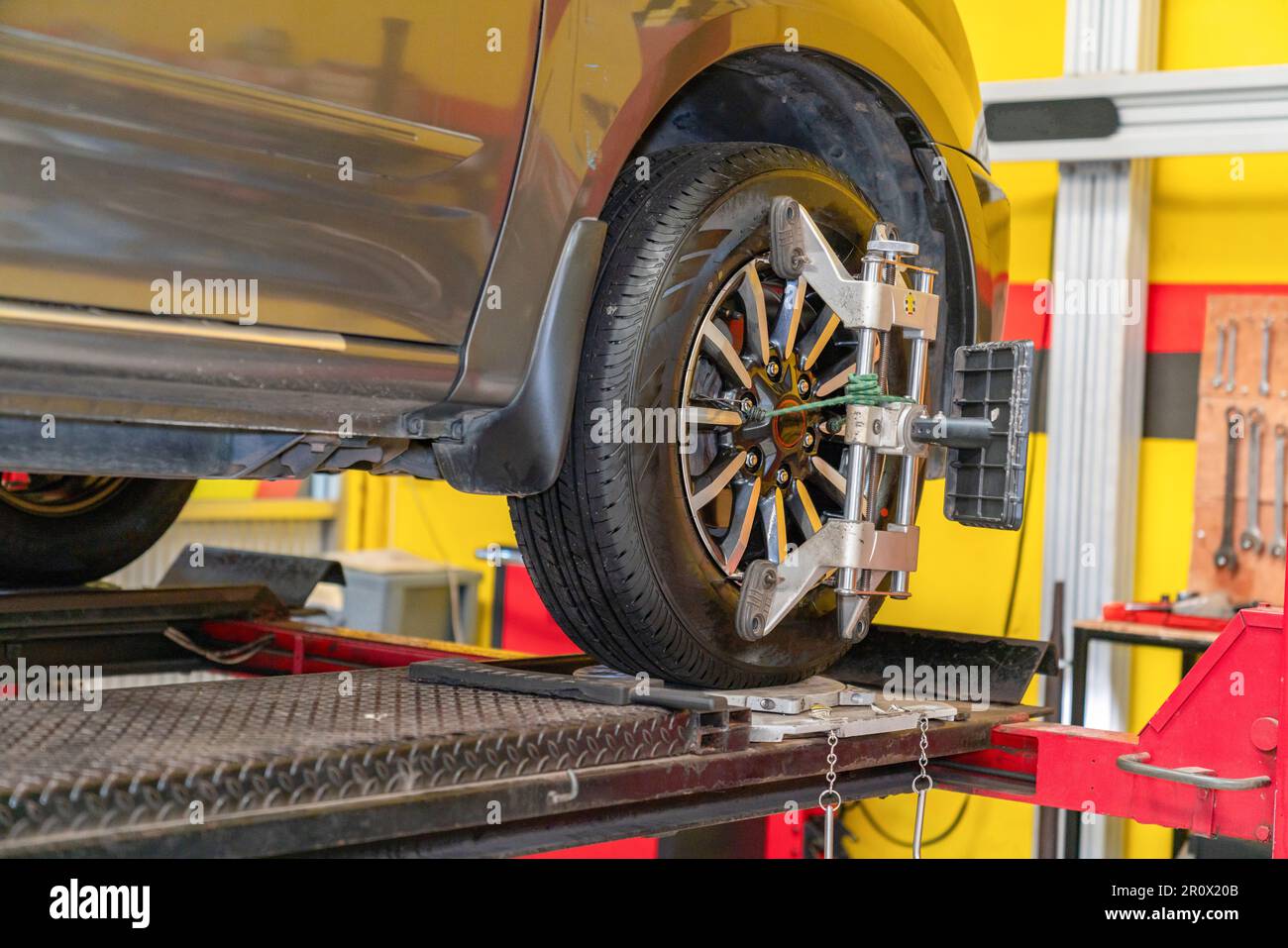 CLose-up car wheel indoors service maintenance repair center. Fixed and ...