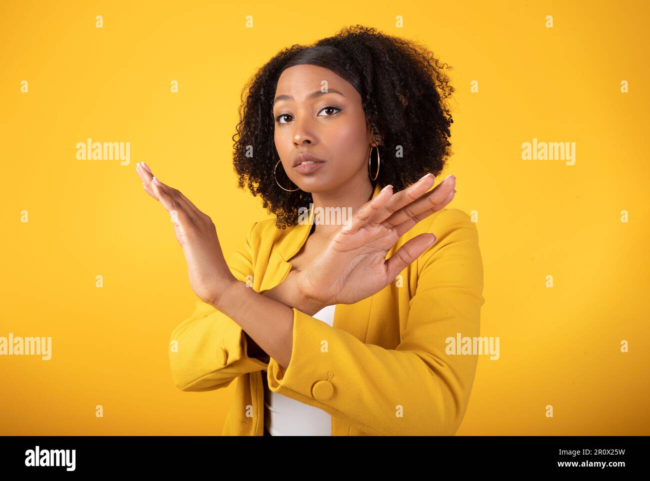 Rejection and warning concept. Displeased black lady crossing hands in ...