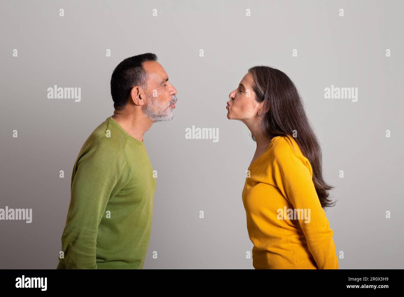 Cheerful caucasian elderly man and wife make kiss, enjoy free time on ...