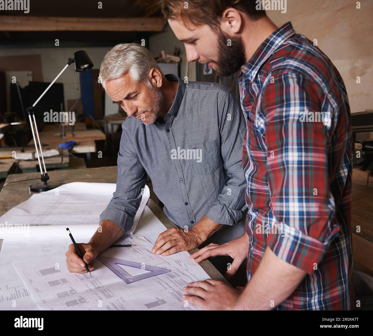 Carpenter men, teamwork and drawing on paper with discussion ...