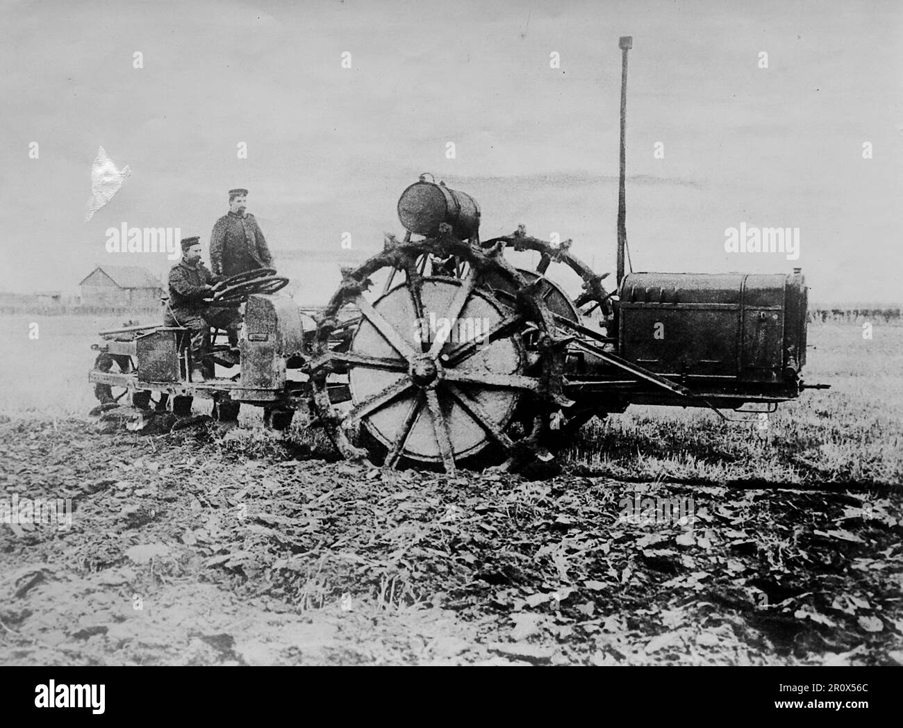 WWI. German soldiers operating a motor plough in countryside they have ...