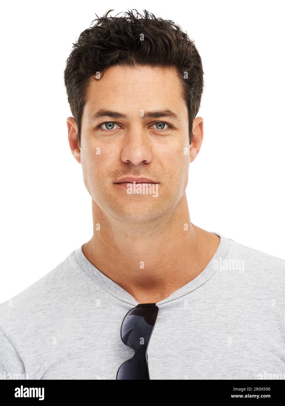 Ruggedly good-looking. Handsome young guy looking at the camera while ...