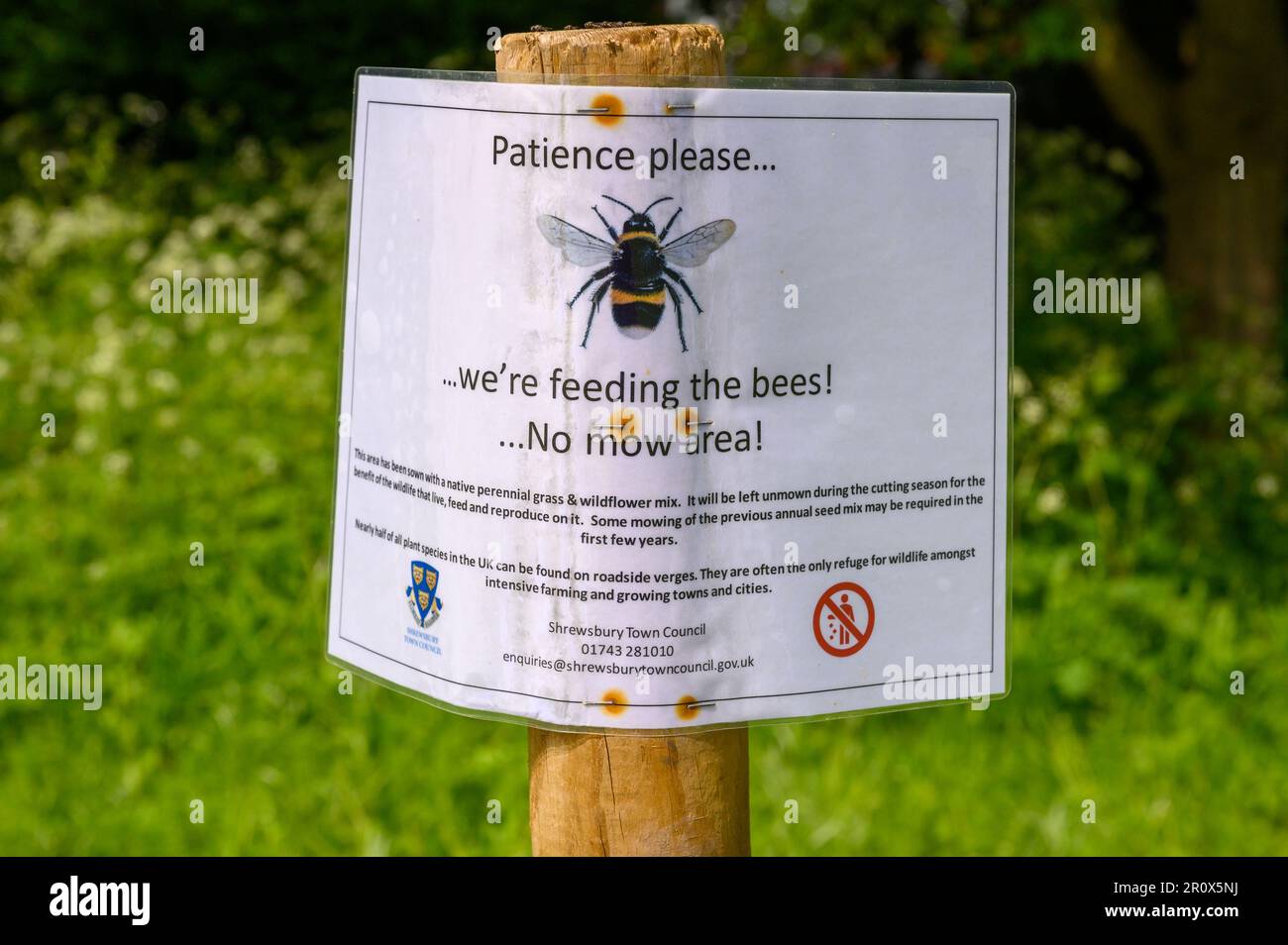 Sign in a public area telling people that the area will not be mowed to ...