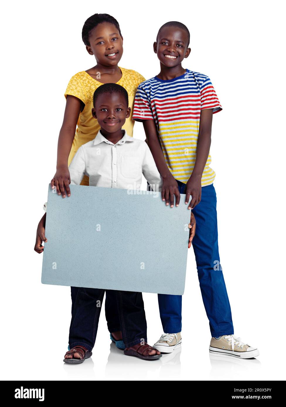 A message from us. Studio shot of three african siblings with a blank ...