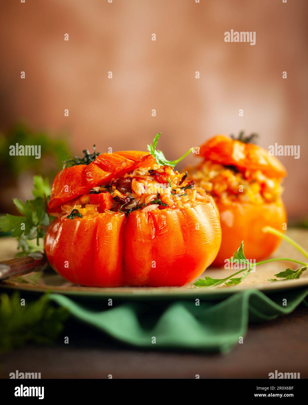 Delicious stuffed tomatoes in shape of pumpkin with rice, vegetables ...
