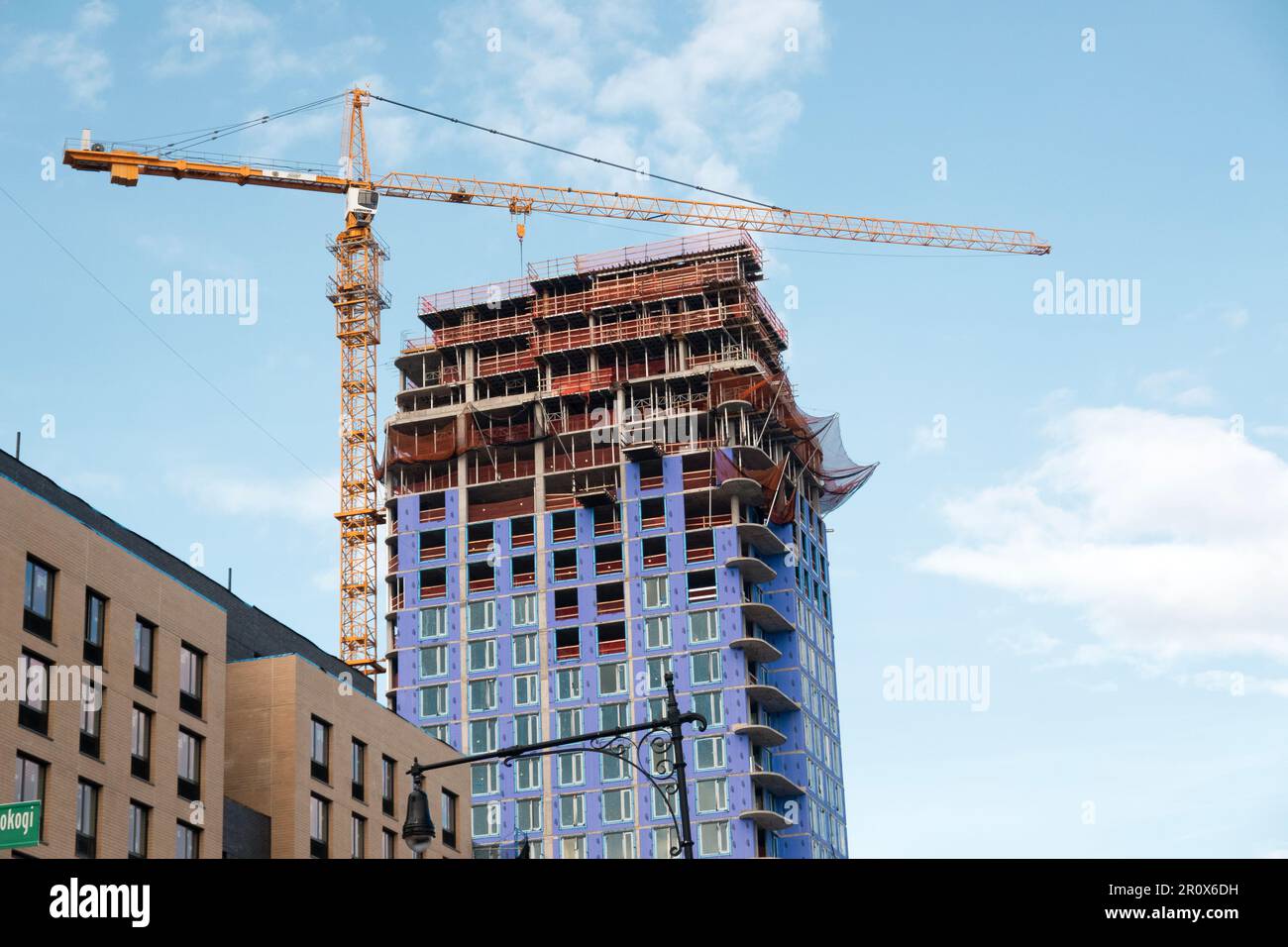 A very large sized crane operating in the construction of a tall ...