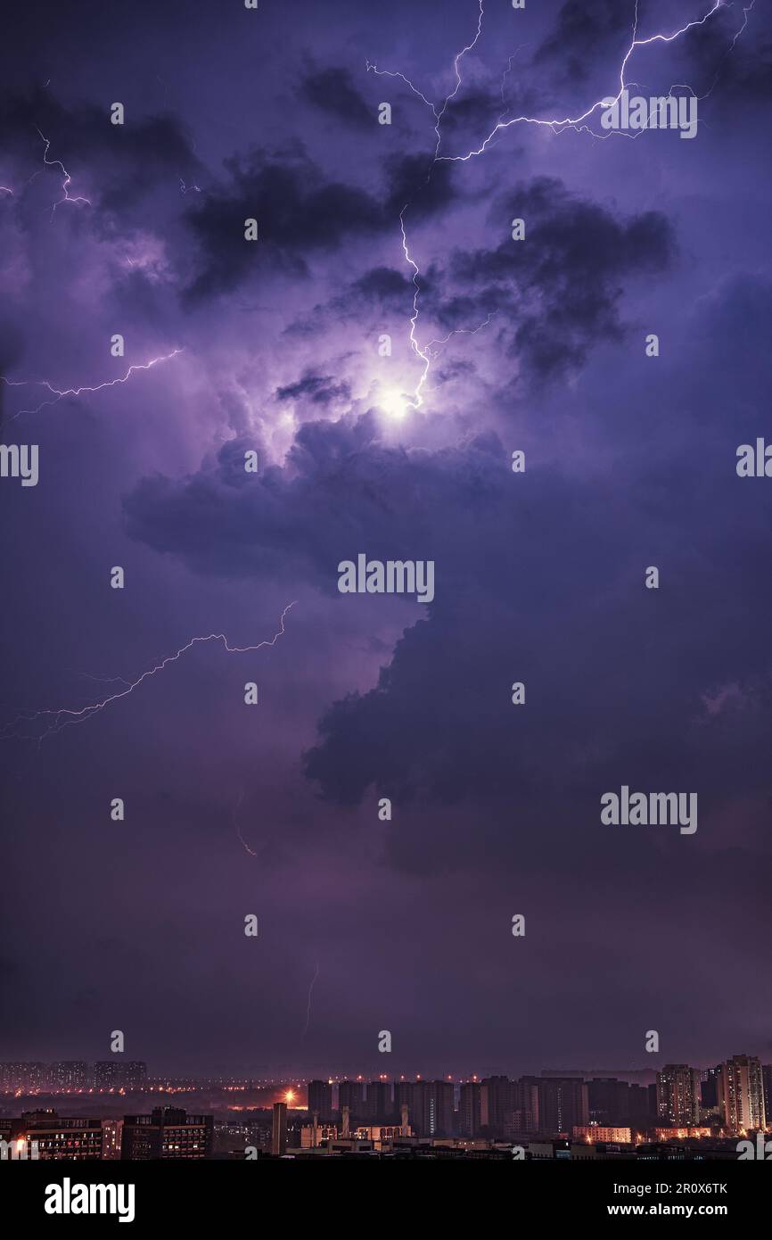 A dramatic view of a storm illuminating the night sky with flashes of ...