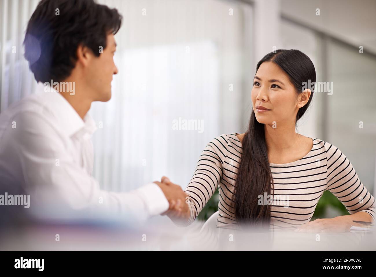 I think that went really well. two businesspeople shaking hands while ...