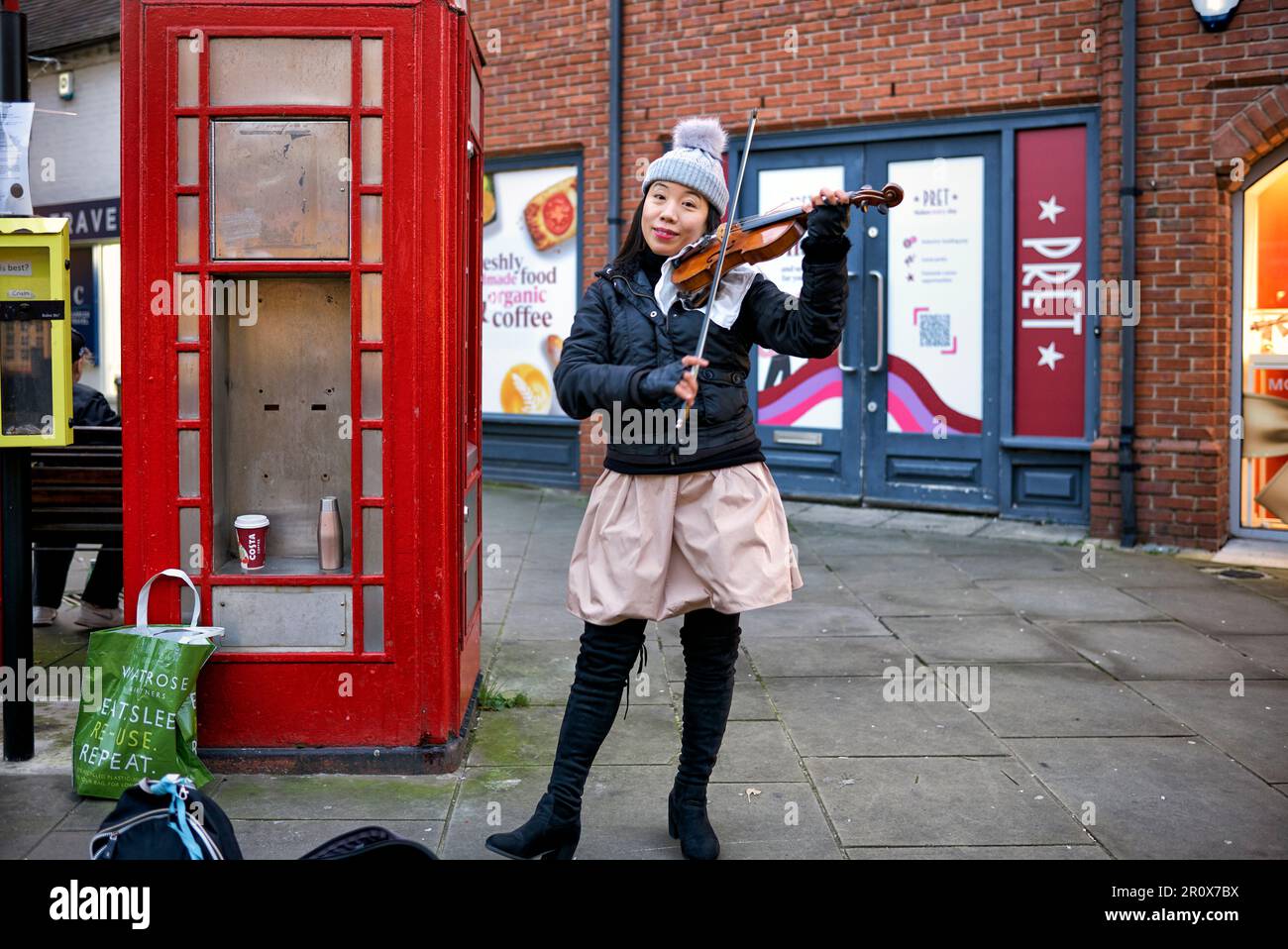 Chinese woman street musician or busker playing the violin at Stratford ...