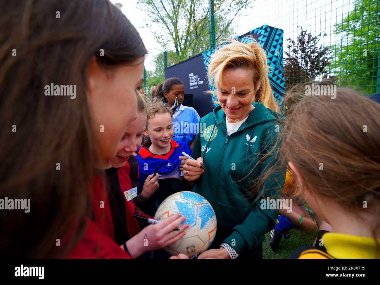 Republic of Ireland manager Vera Pauw autographs a football for school ...