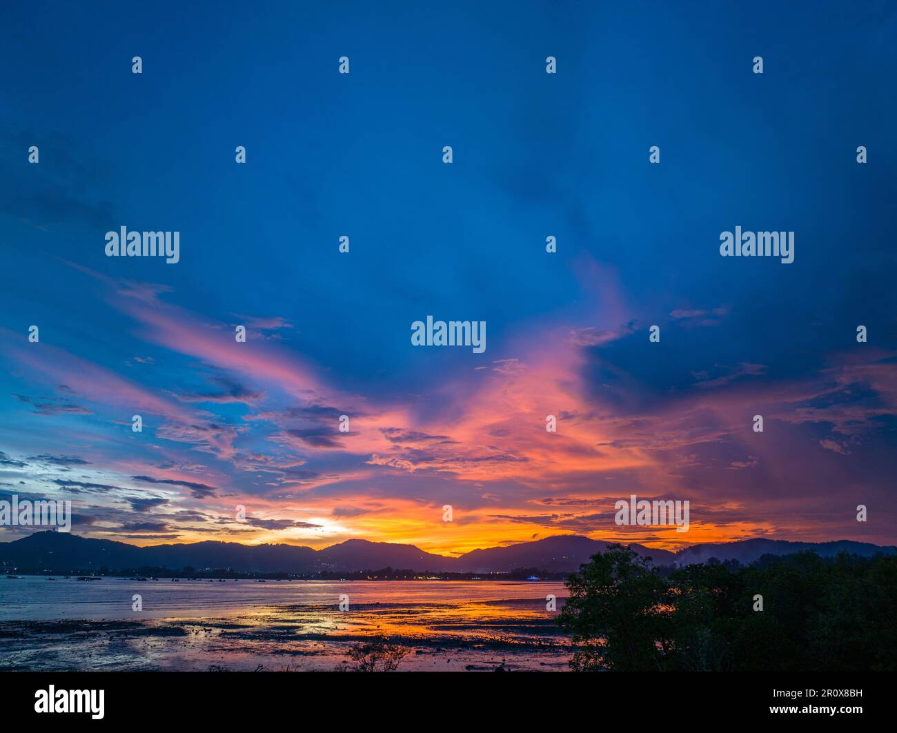 aerial view reflection of colorful cloud in bright sky of sunset above the ocean at Khao Khad ...