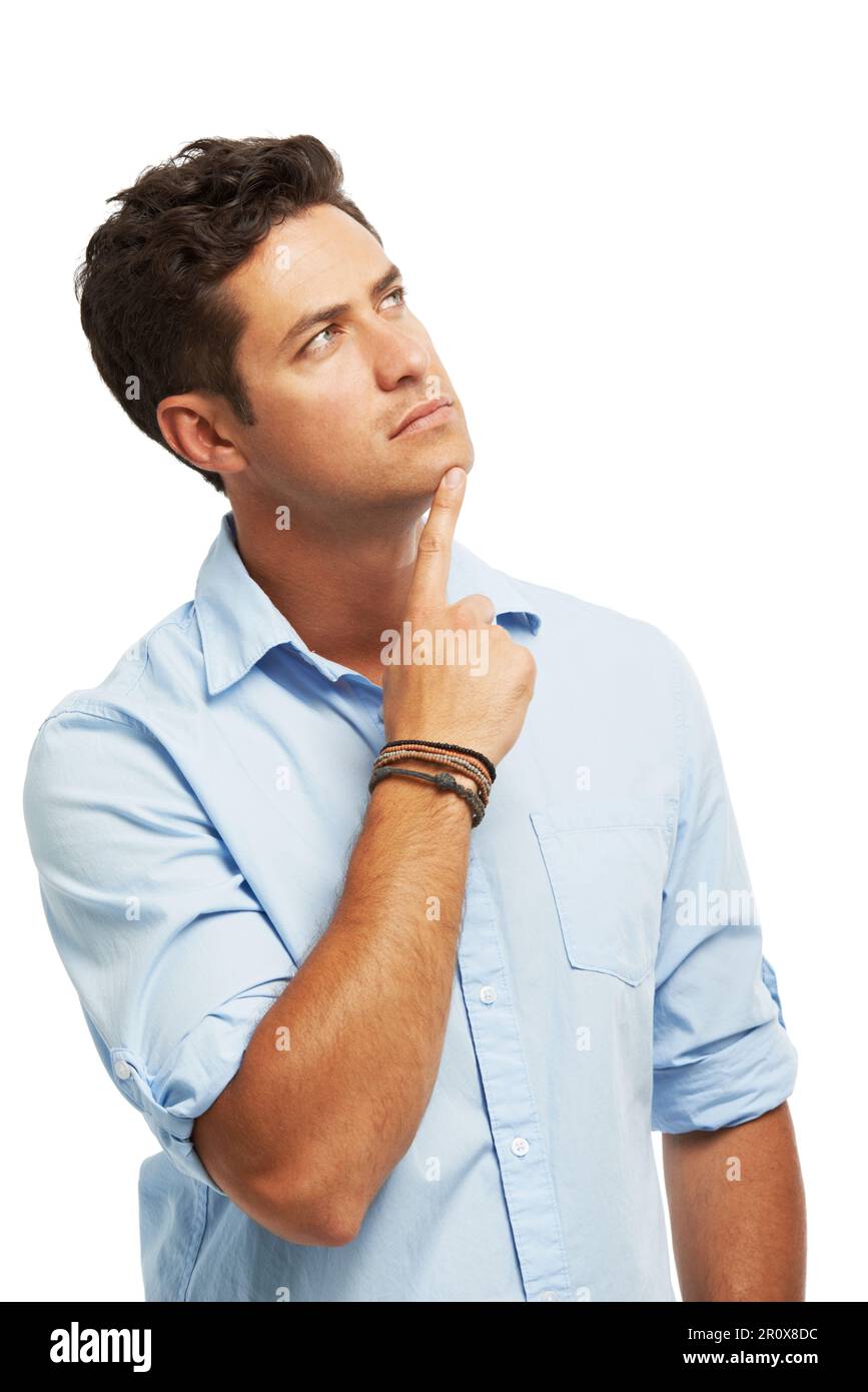Pondering the options. A young man looking upwards thoughtfully while ...