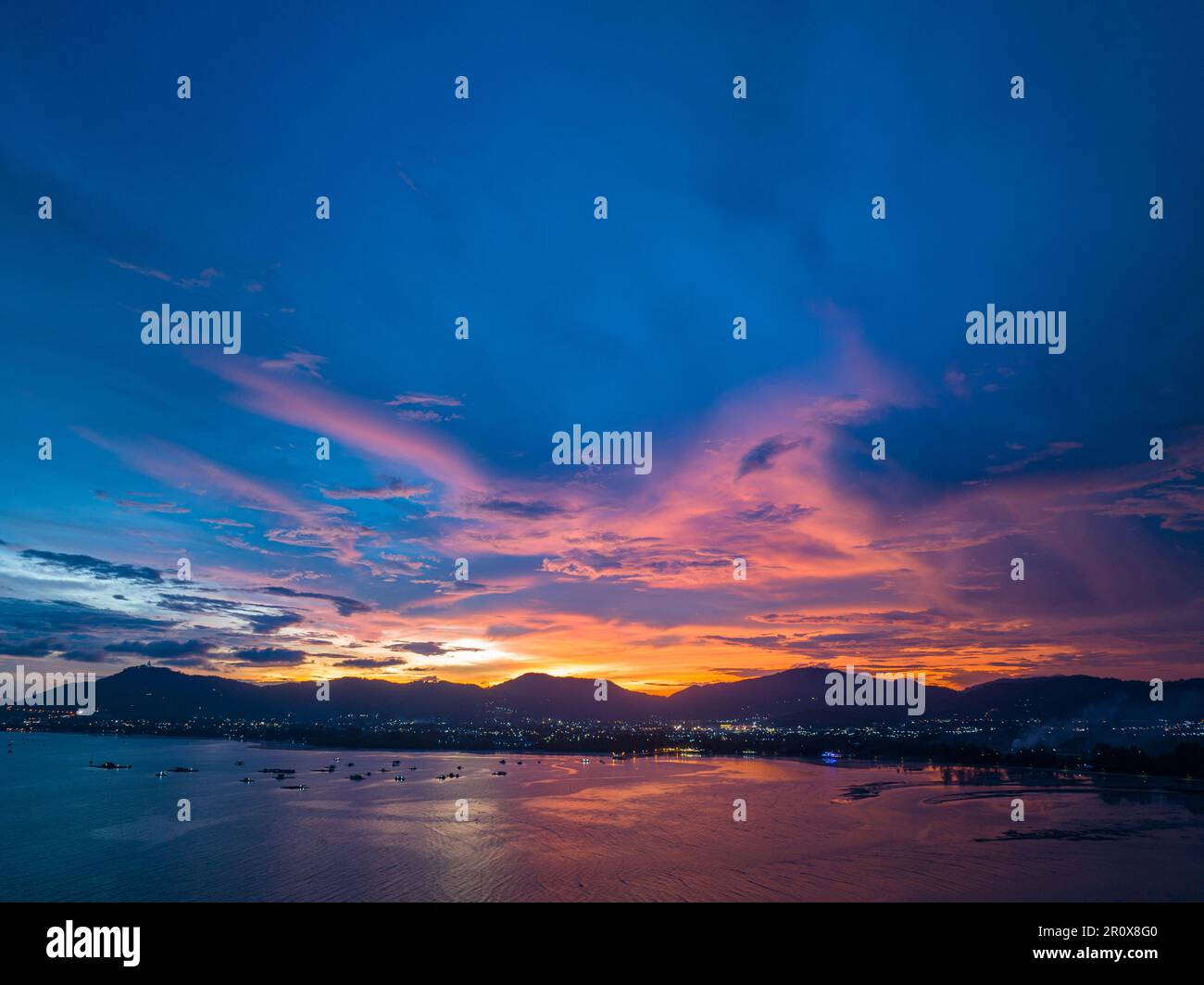 aerial view reflection of colorful cloud in bright sky of sunset above the ocean at Khao Khad ...