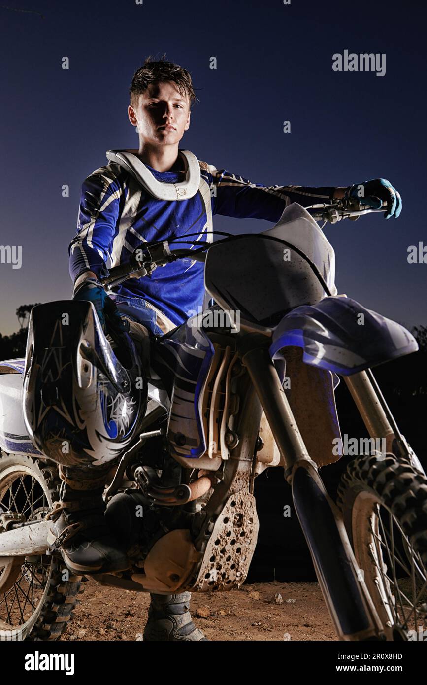 Confident on his dirtbake. Portrait of a young motocross rider posing ...
