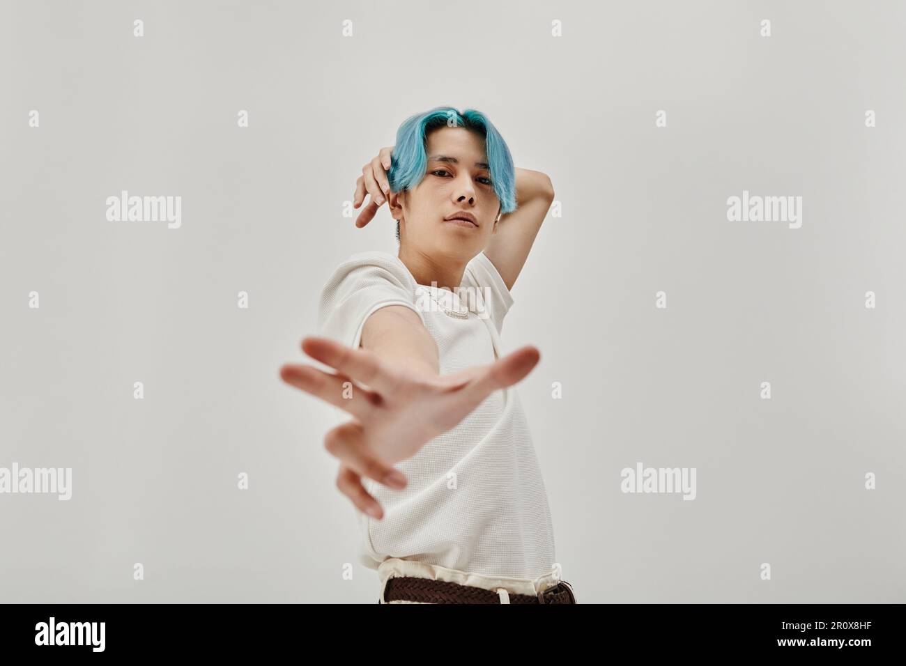 Asian young dancer with blue hair exercising on white background Stock ...