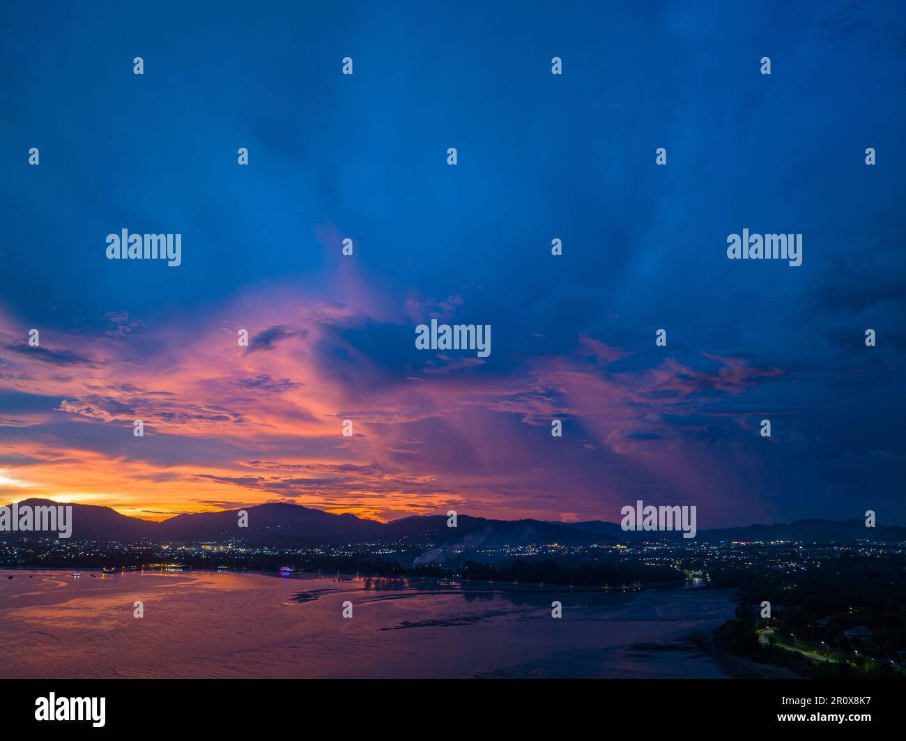 aerial view reflection of colorful cloud in bright sky of sunset above the ocean at Khao Khad ...