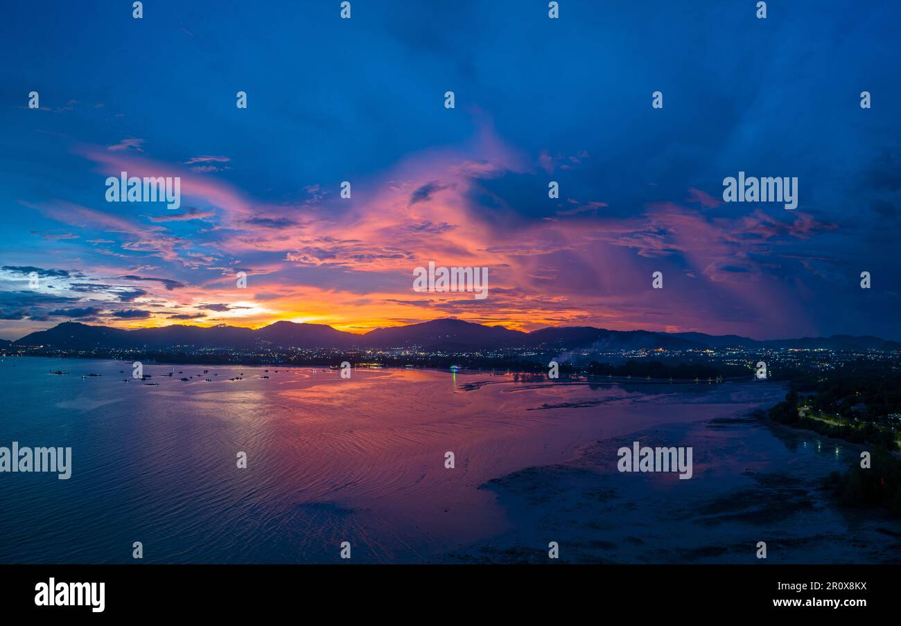 aerial view reflection of colorful cloud in bright sky of sunset above the ocean at Khao Khad ...