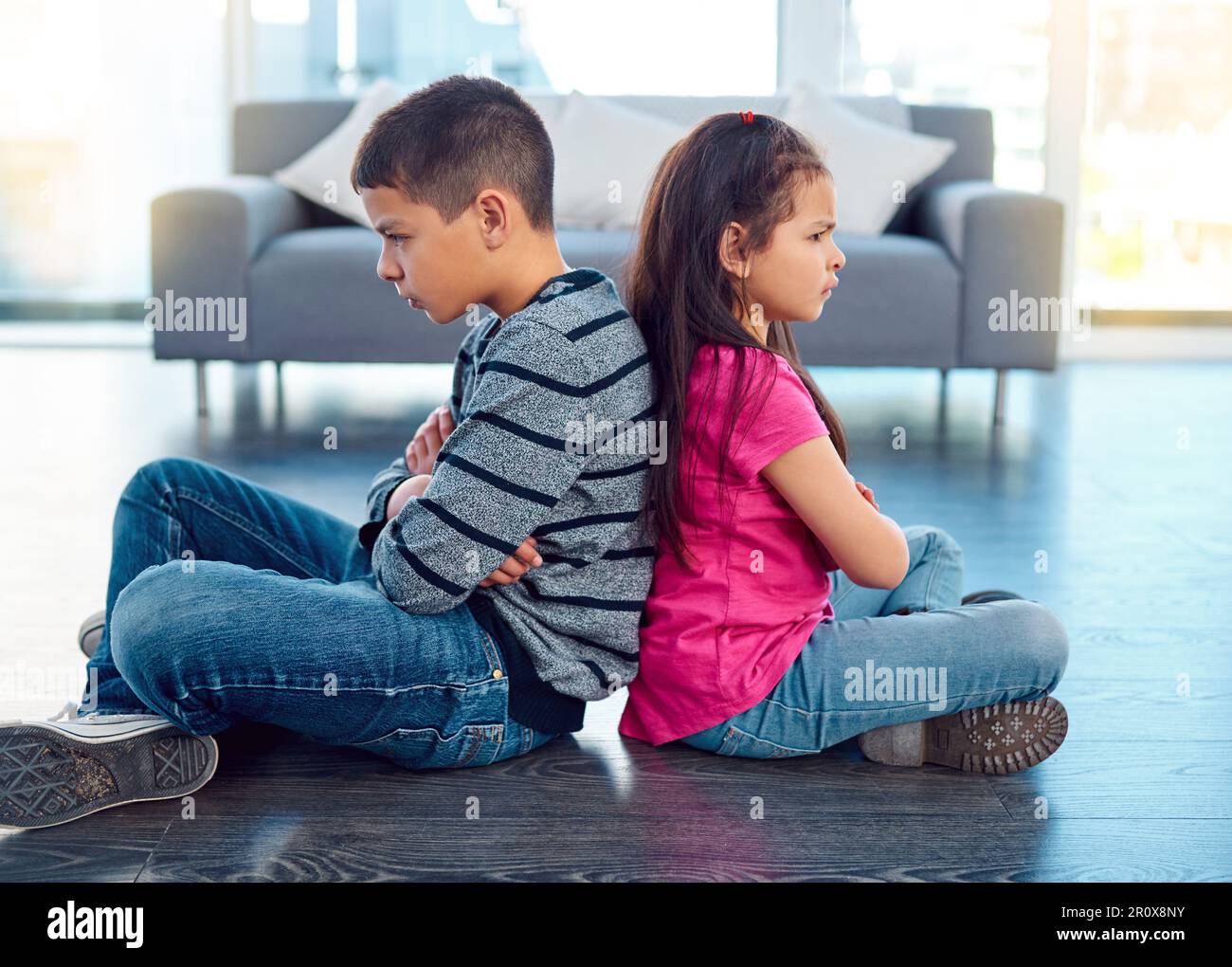 Angry, brother and sister in home living room, fighting or argument ...