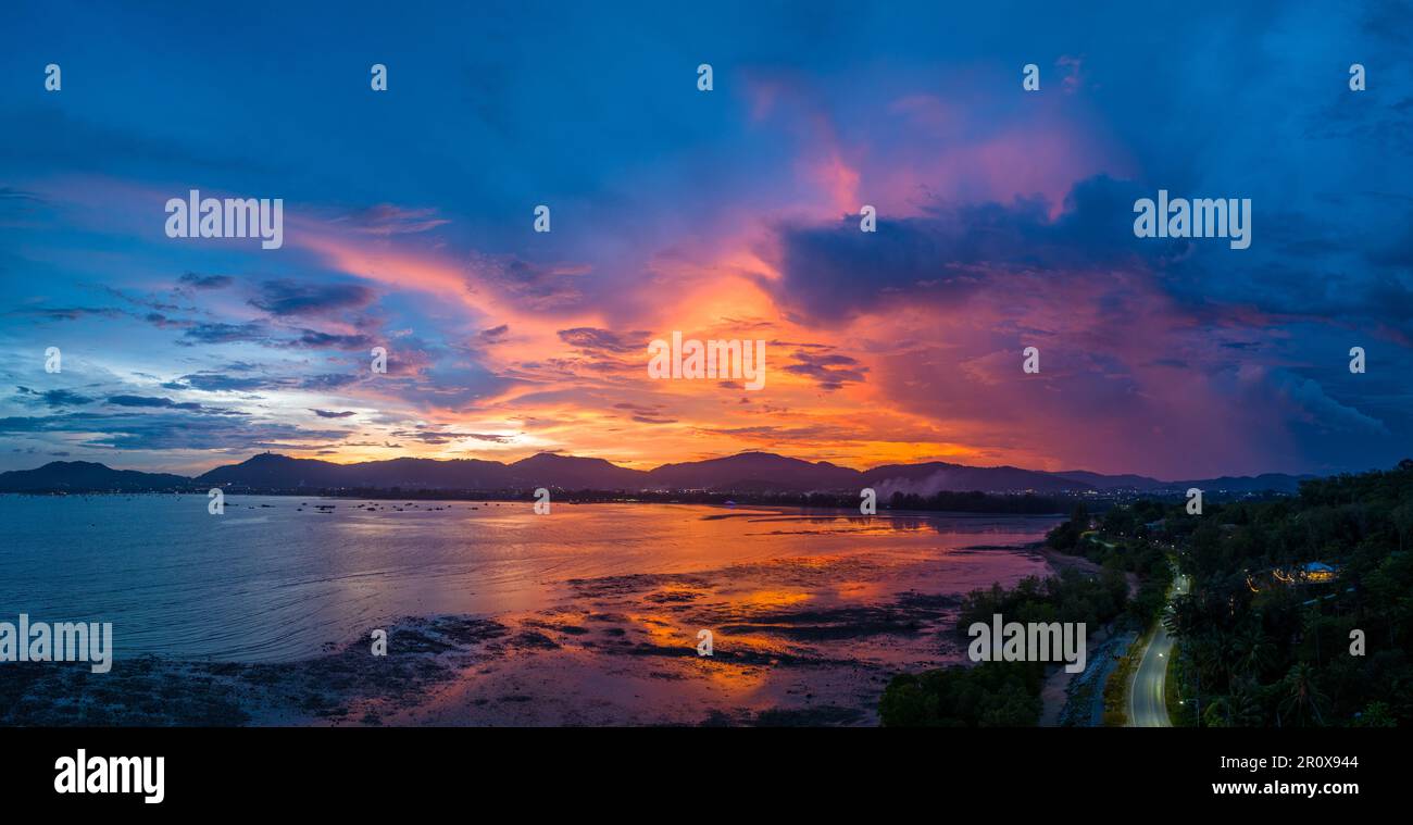 aerial view reflection of colorful cloud in bright sky of sunset above the ocean at Khao Khad ...