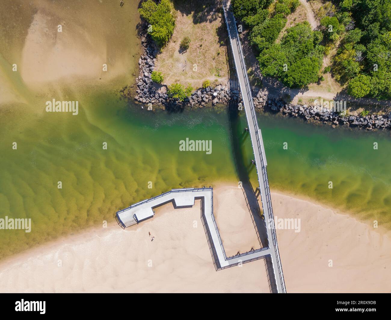 Aerial view of a bridge and jetty over a coastal river at South West ...