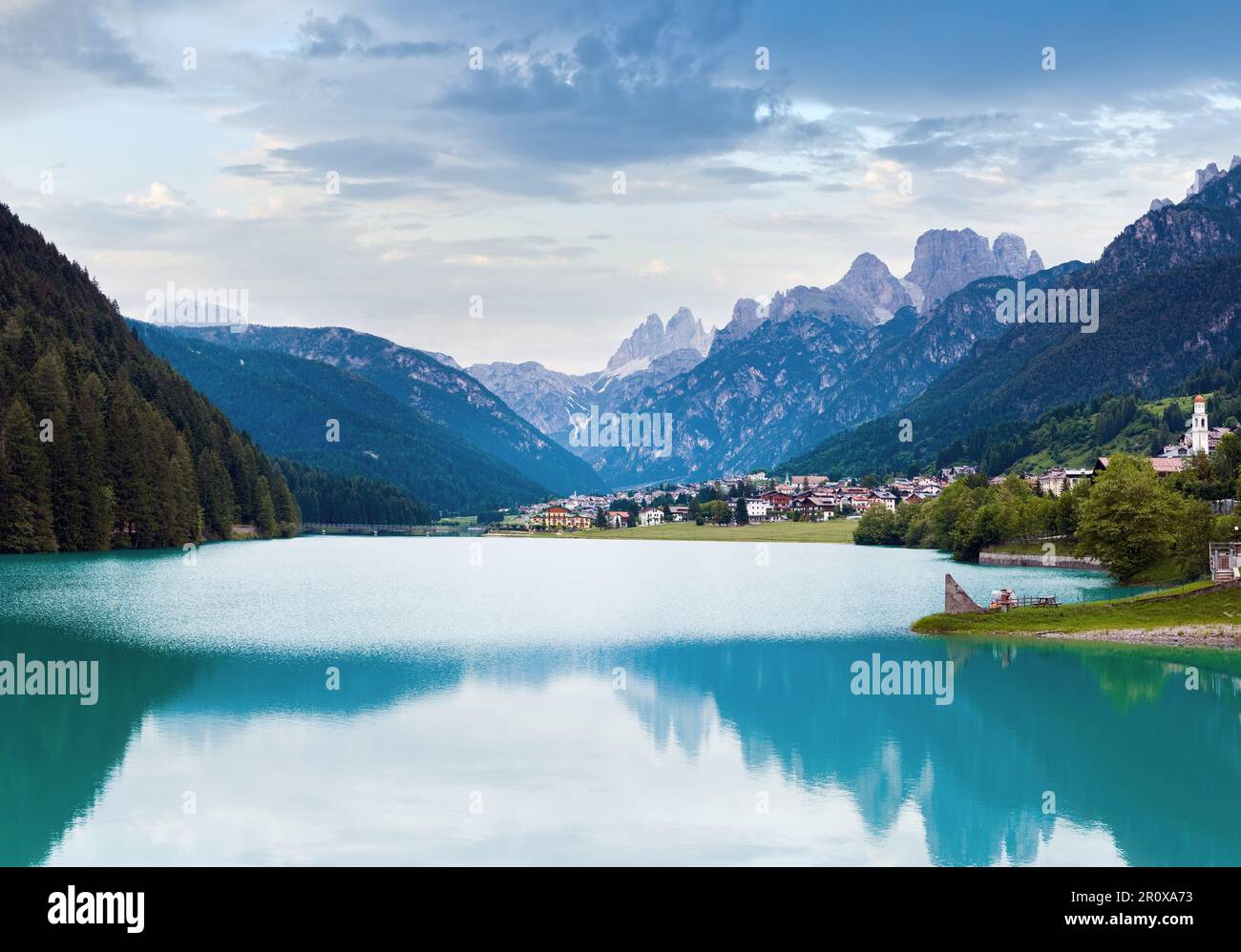 Tranquil summer Italian dolomites mountain lake and village view ...