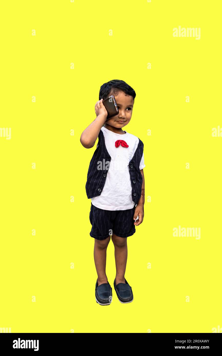 Little Boy Having a Serious Phone Call Isolated on a Yellow Background ...