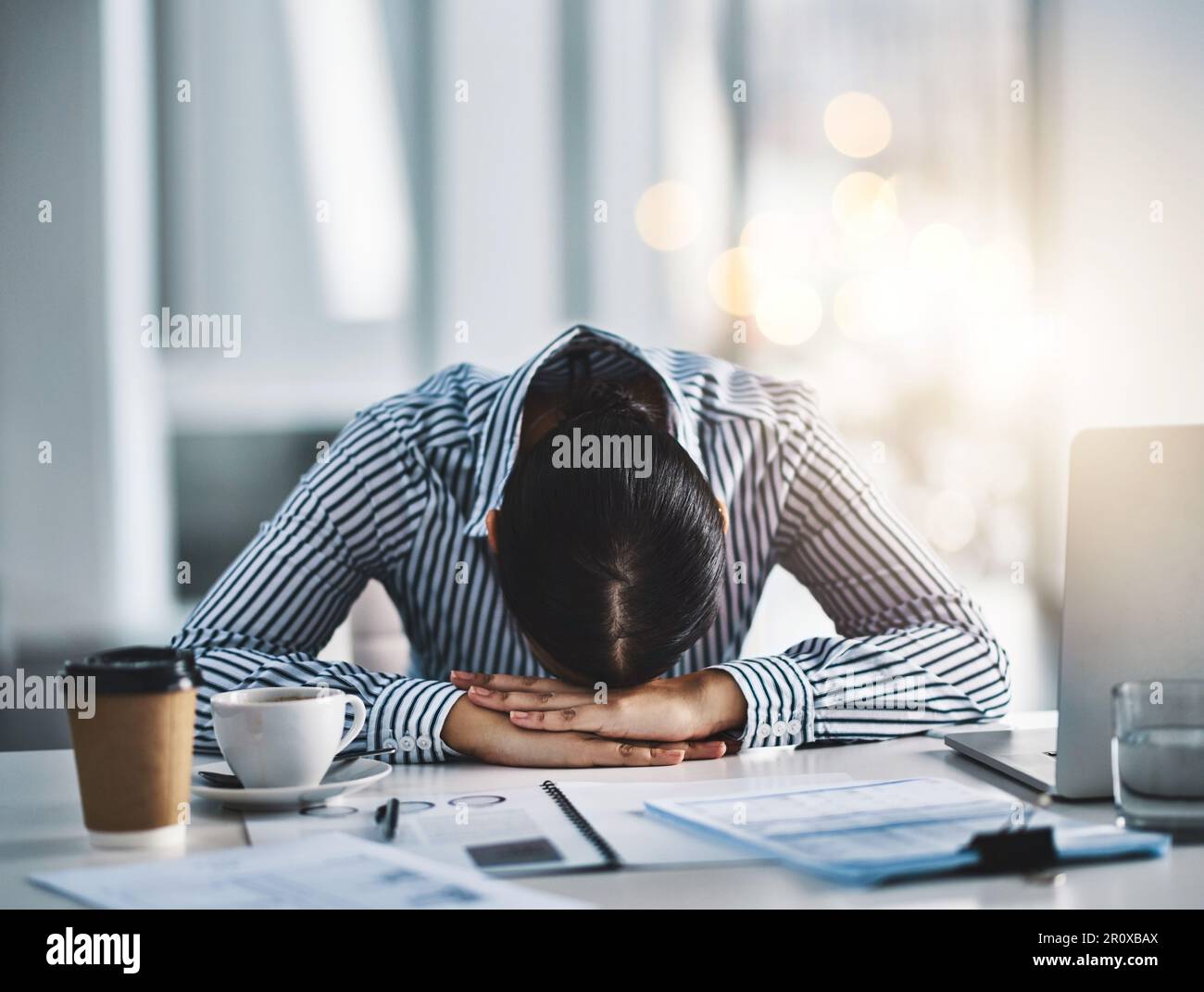 Sleeping, tired and business woman at desk for headache, overworked and ...