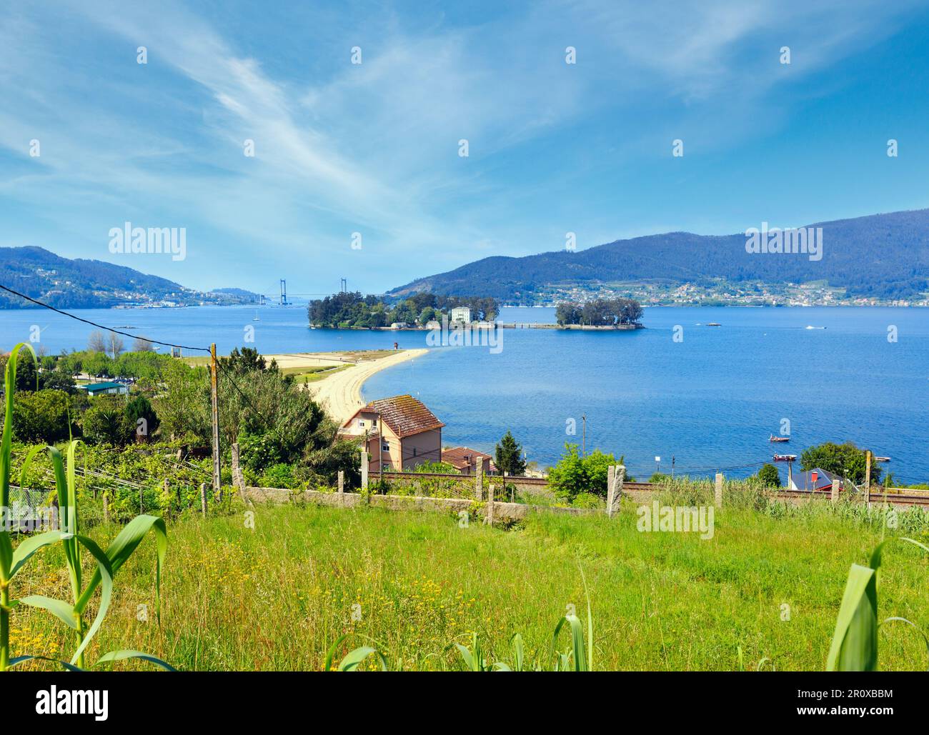 Sandy beach in Cesantes town and San Simon island (Galicia, Spain ...