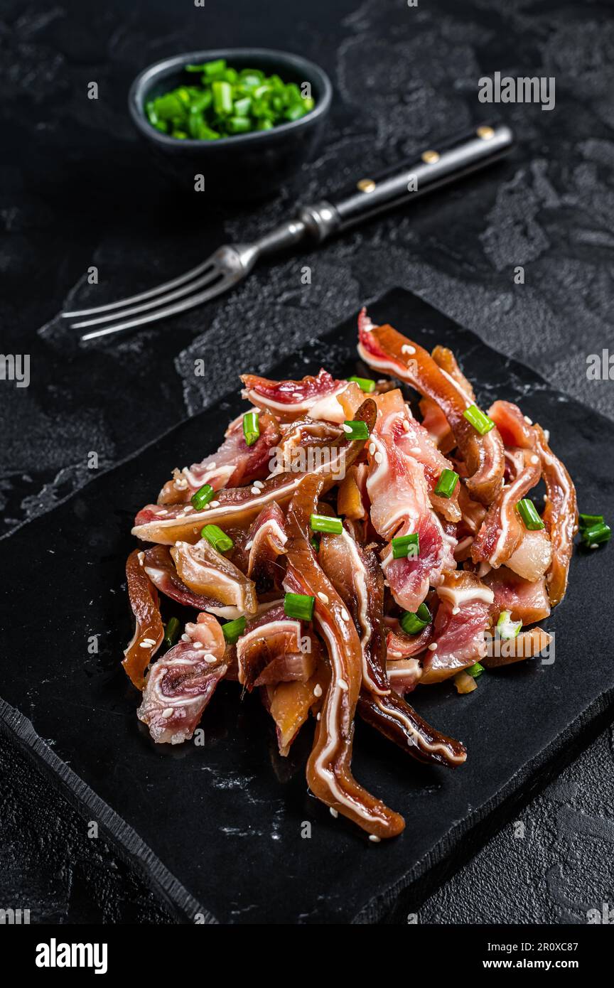 Fried pig ears with sesame seeds and green onions. Fried pork ears in ...