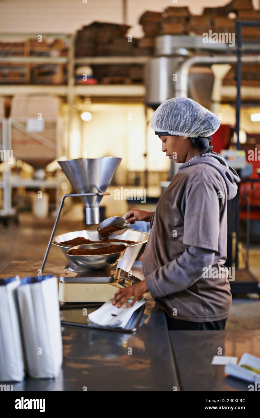 Soon to be in your cup from the production floor. a worker in a coffee ...