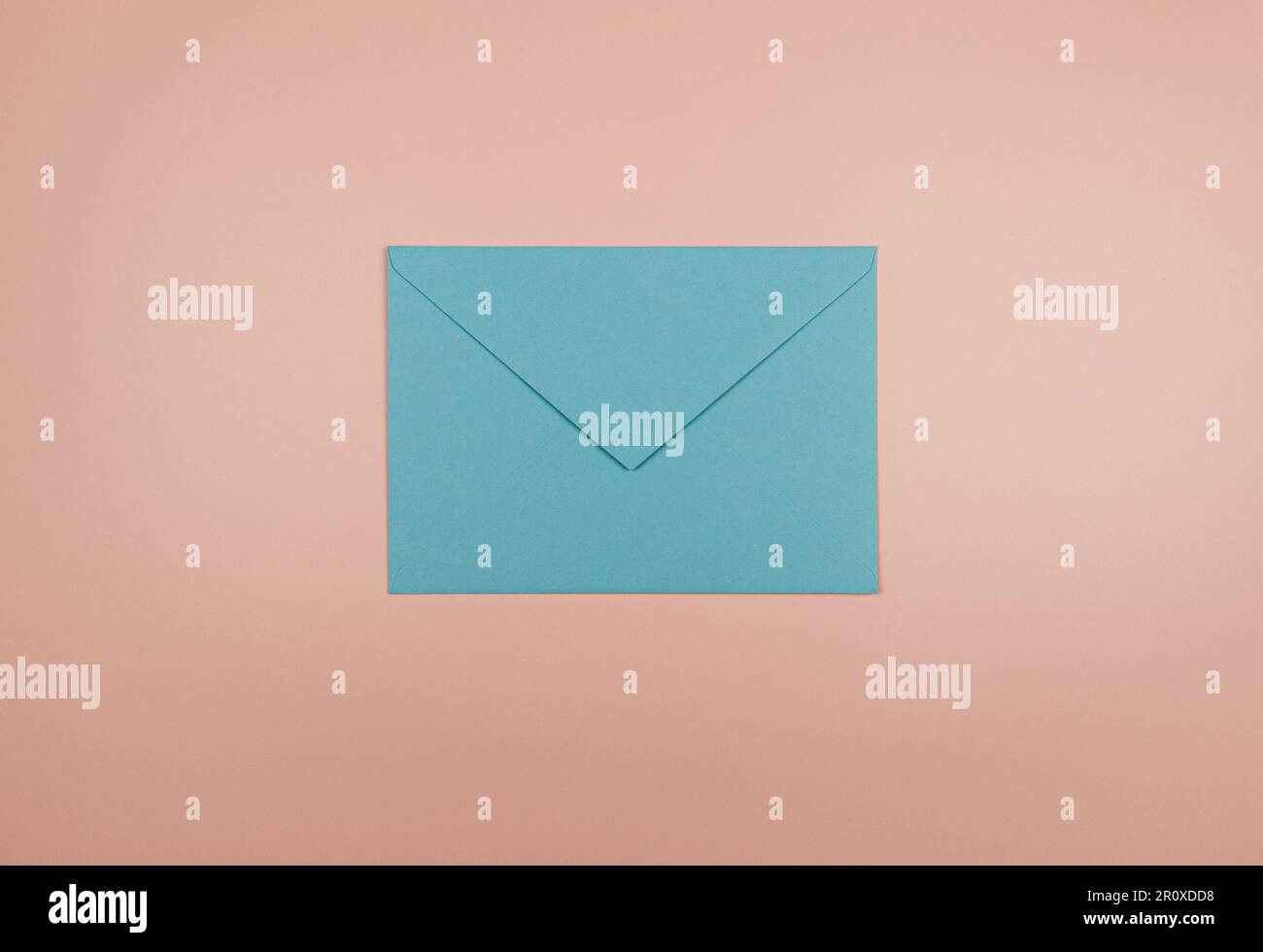 Top view of light blue envelope on pink background. Post flat lay, copy ...