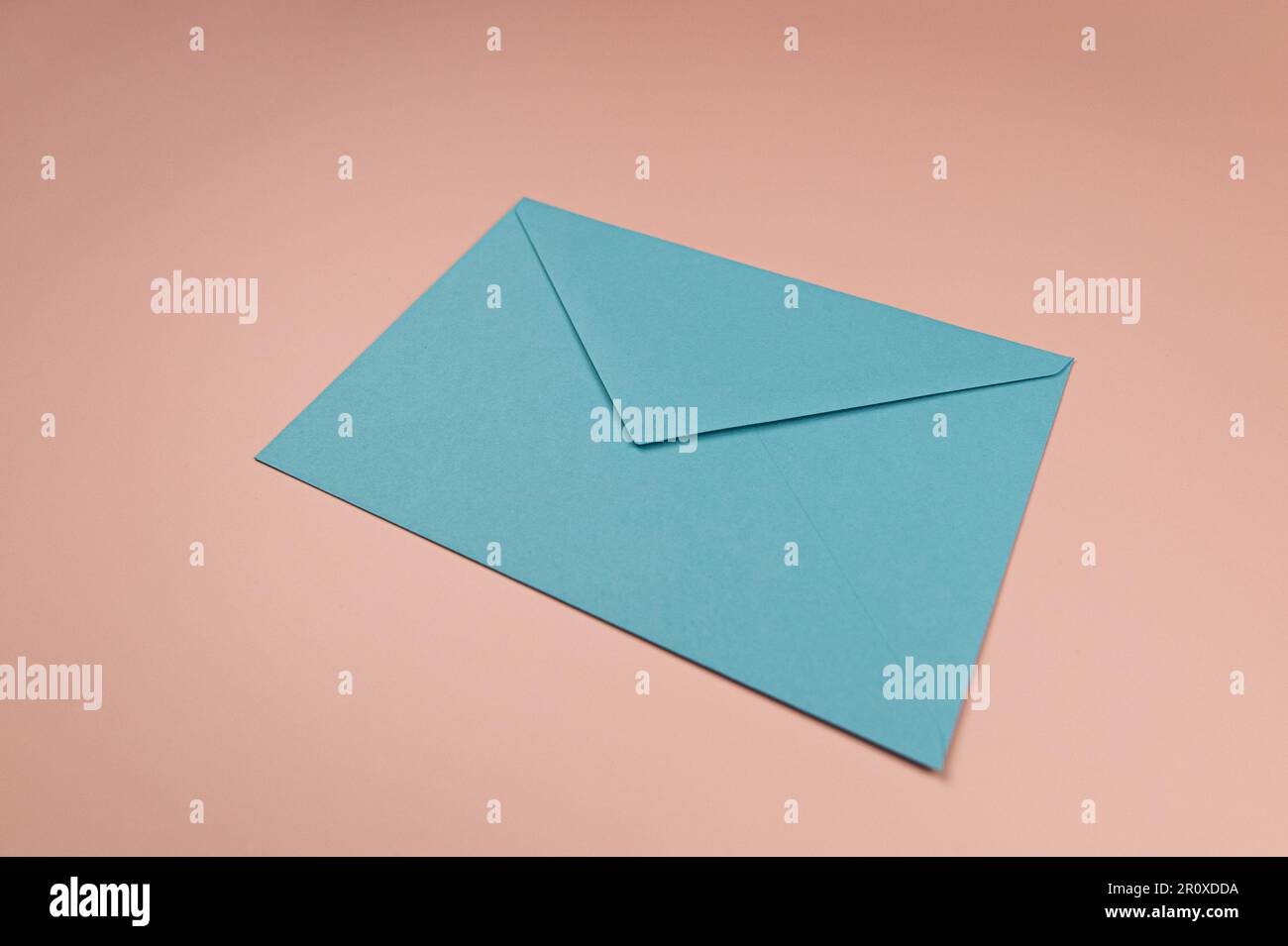 Top view of light blue envelope on pink background. Post flat lay, copy ...